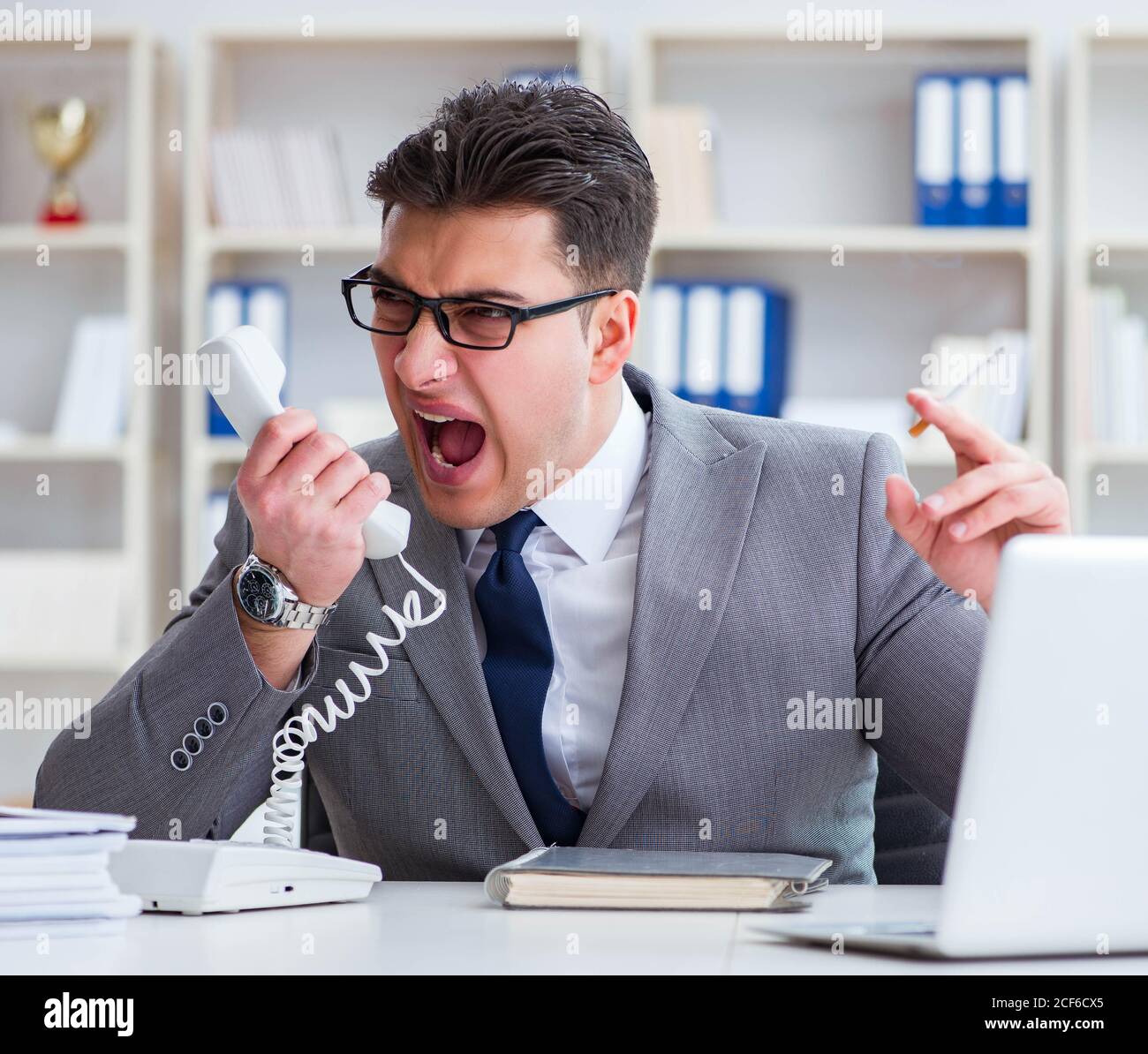 The businessman smoking in office at work Stock Photo - Alamy