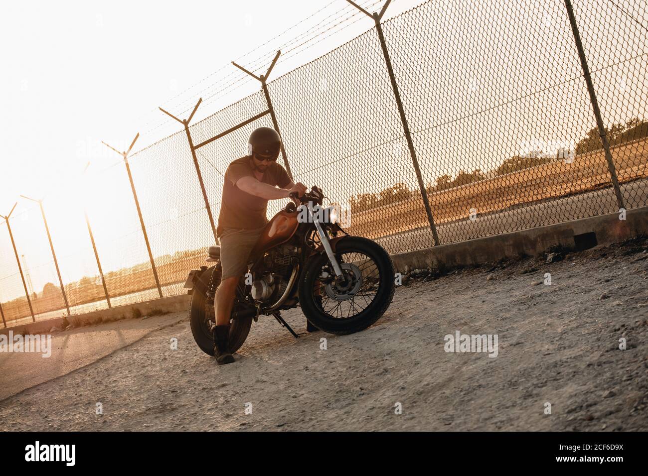 Strong man driving motorcycle Stock Photo - Alamy