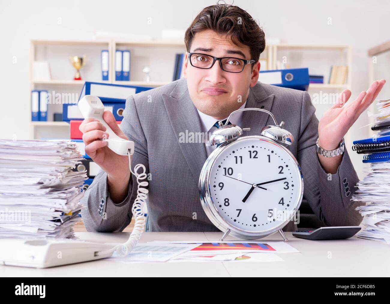 The businessman missing deadlines due to excessive work Stock Photo - Alamy
