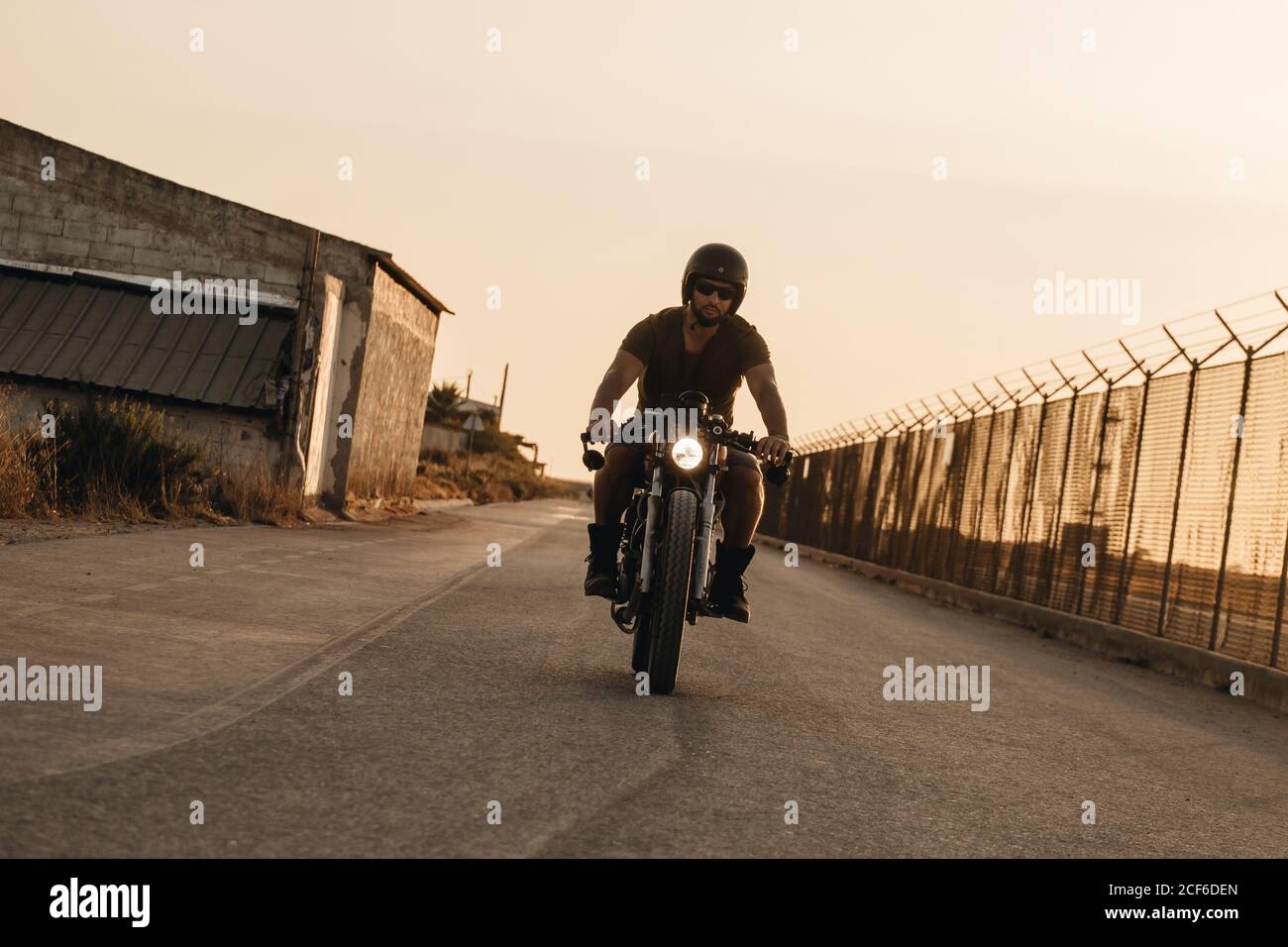 Strong man driving motorcycle Stock Photo - Alamy