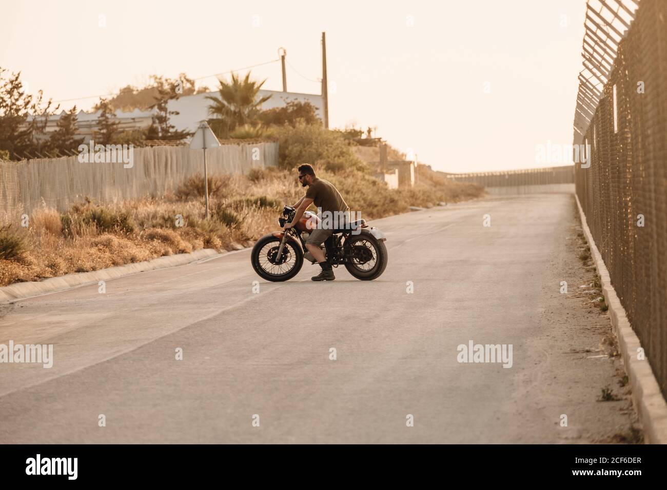 Strong man driving motorcycle Stock Photo - Alamy