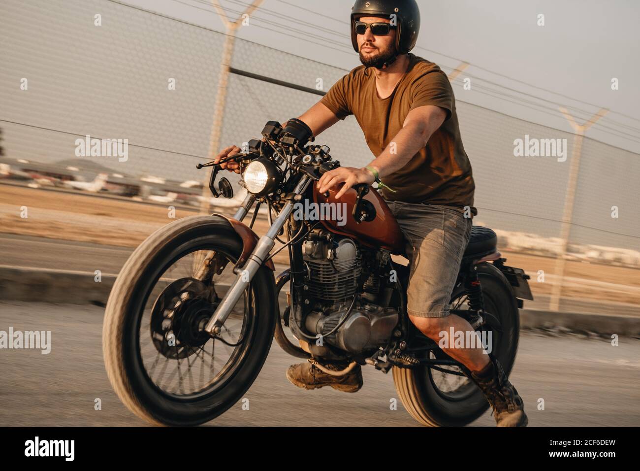 Strong man driving motorcycle Stock Photo - Alamy