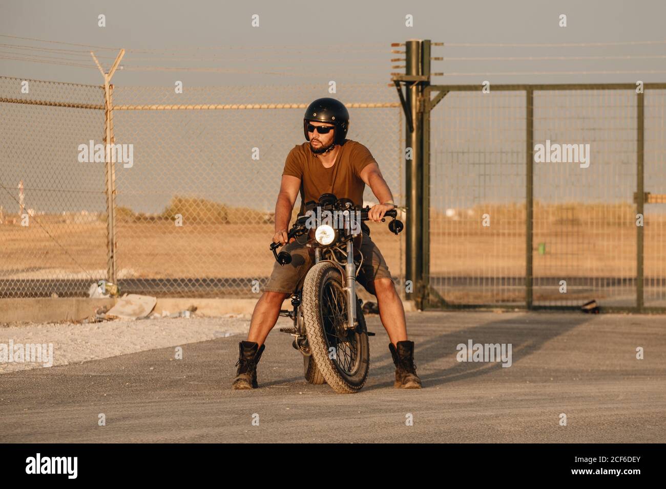 Strong man driving motorcycle Stock Photo - Alamy
