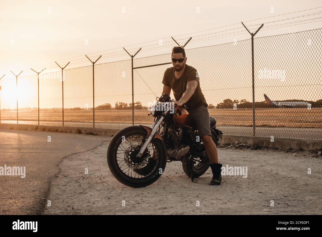 Strong man driving motorcycle Stock Photo - Alamy