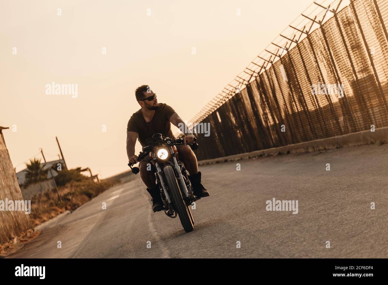 Strong man driving motorcycle Stock Photo - Alamy