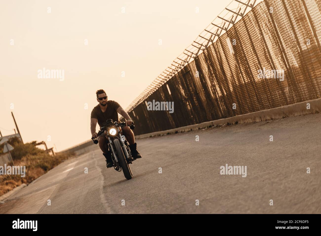 Strong man driving motorcycle Stock Photo - Alamy
