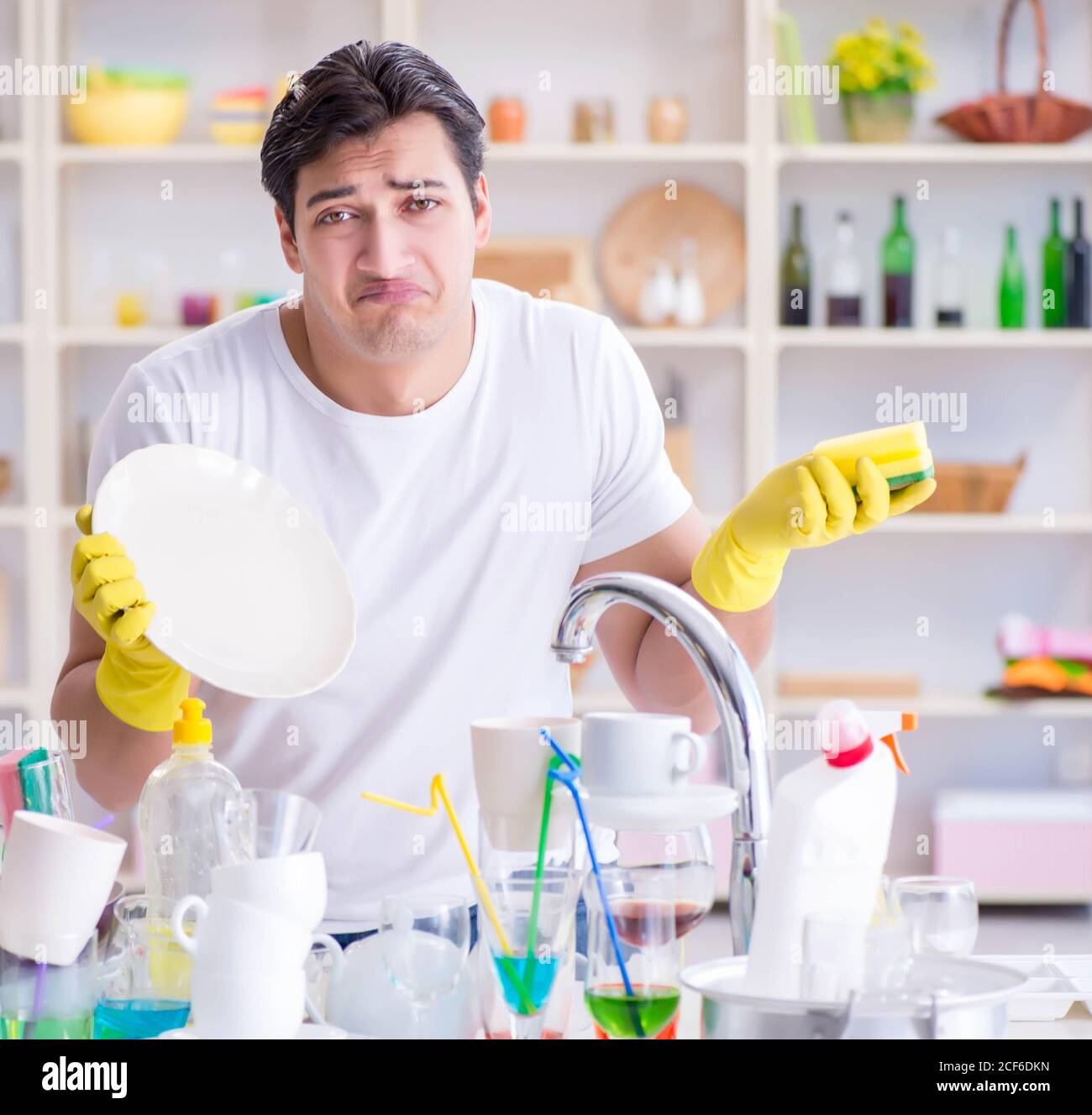 Man frustrated at having to wash dishes Stock Photo - Alamy
