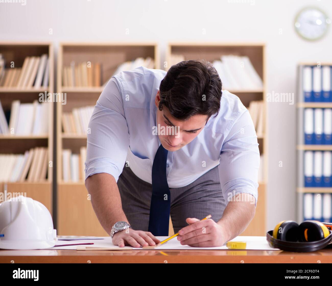 The engineer supervisor working on drawings in the office Stock Photo ...