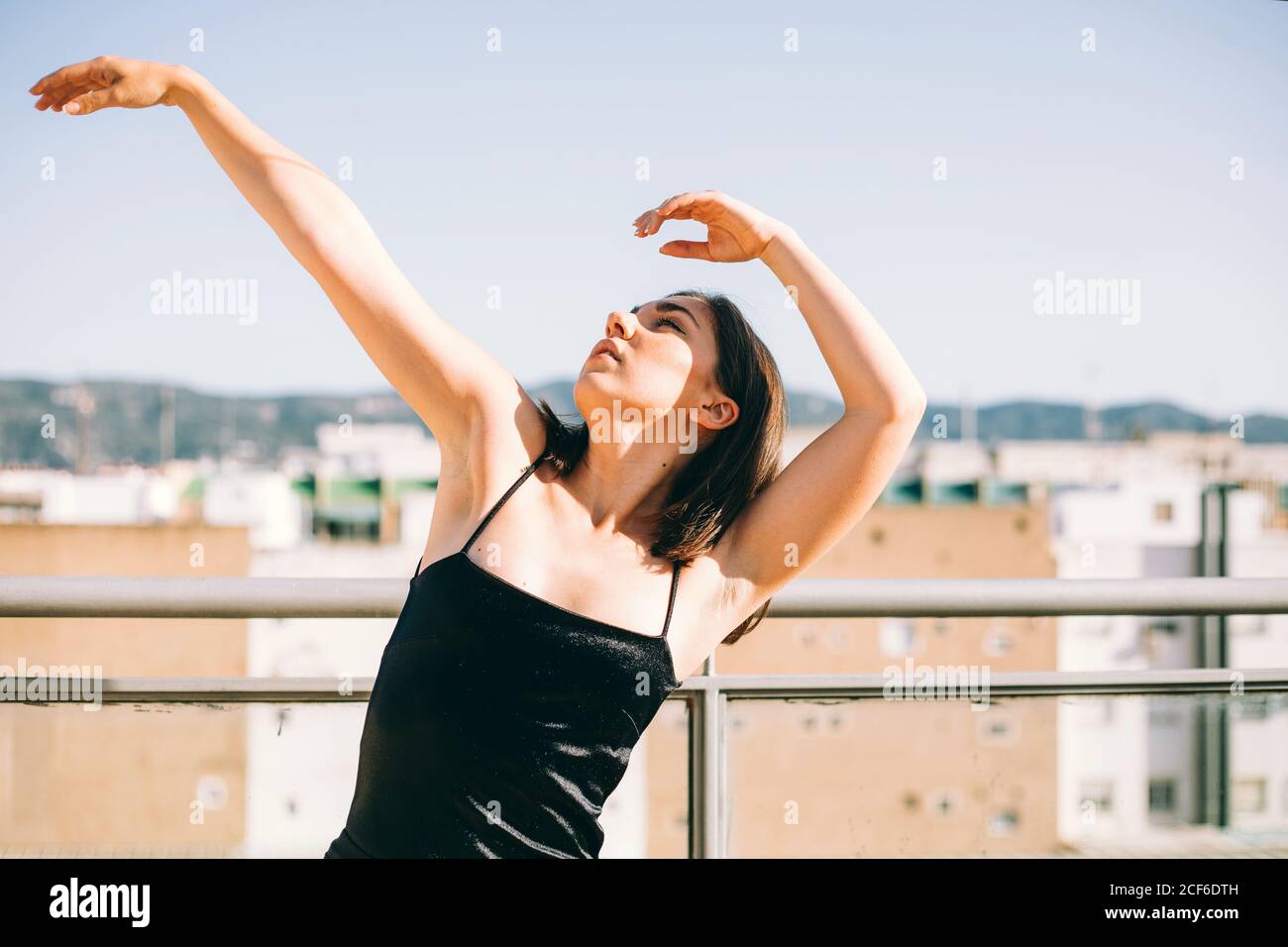 Graceful female dancer in moment of performing element with ...