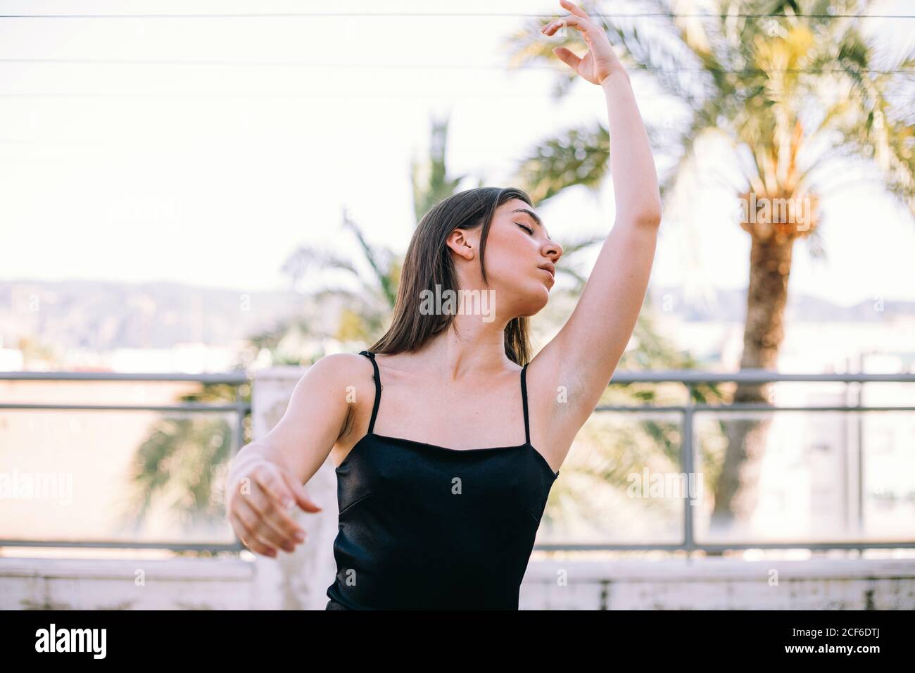 Graceful female dancer in moment of performing element with ...