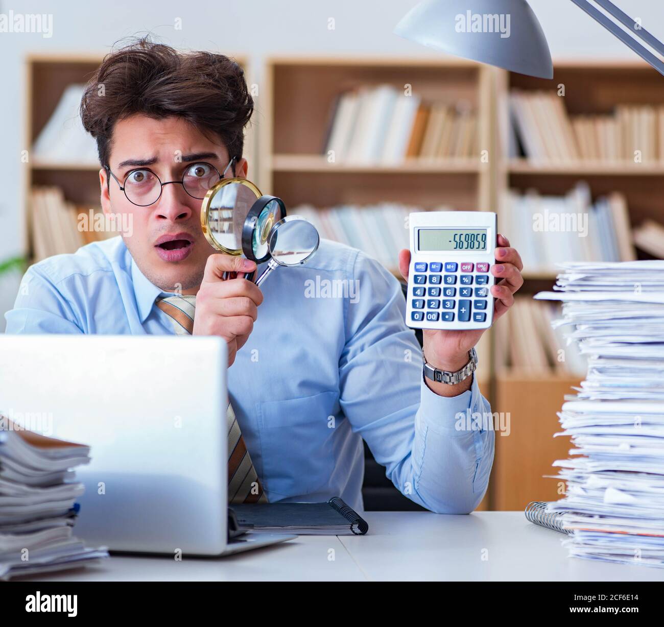 Mad auditor looking for errors in the report Stock Photo - Alamy