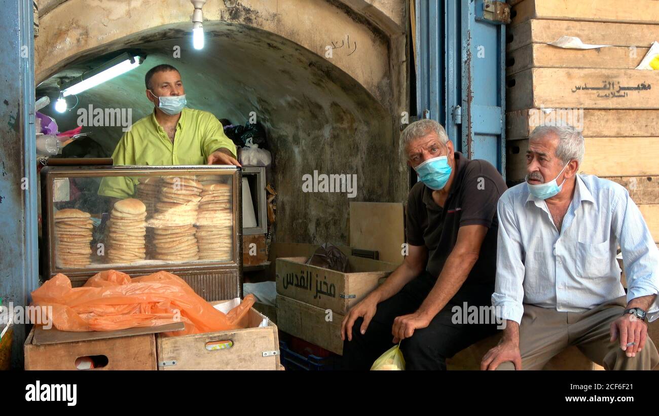 Palestinians wearing protective mask due to the coronavirus pandemic in ...
