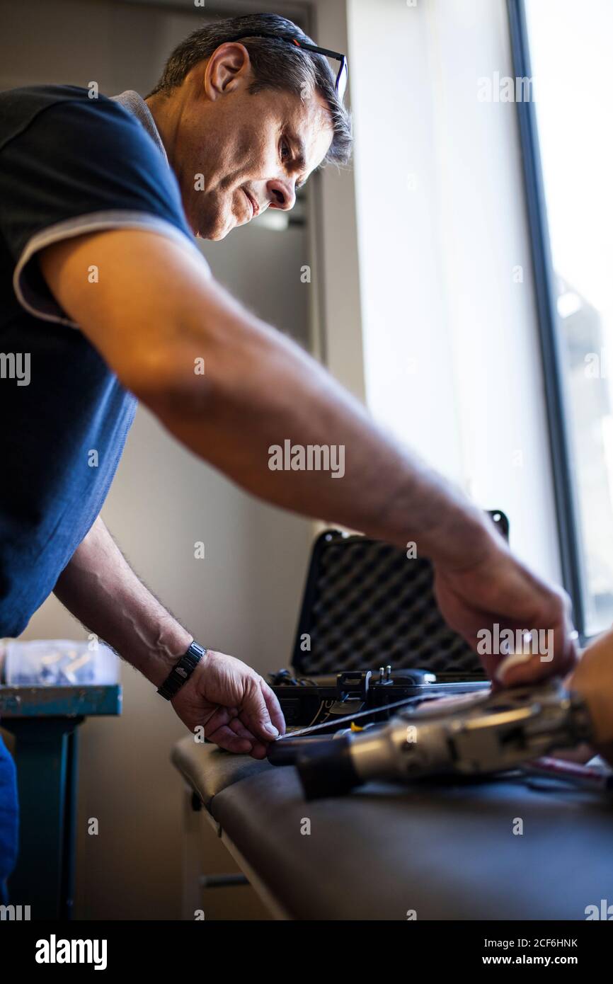 Prosthetic engineer reviewing the prosthesis of a patient and improving ...
