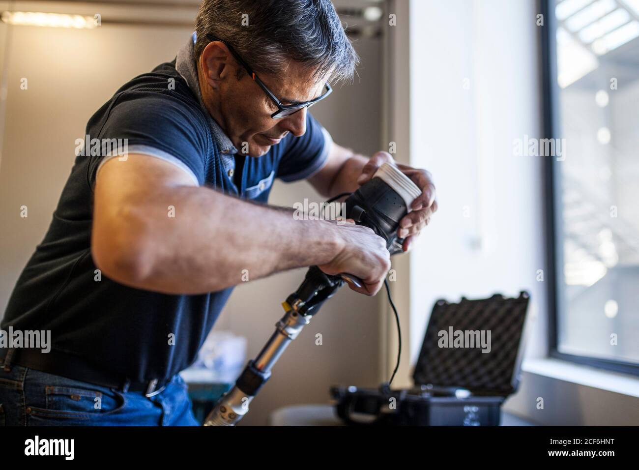 Prosthetic engineer reviewing the prosthesis of a patient and improving ...