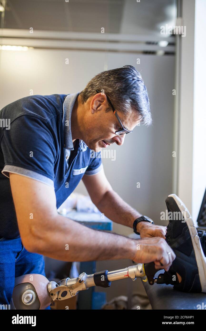 Prosthetic engineer reviewing the prosthesis of a patient and improving ...