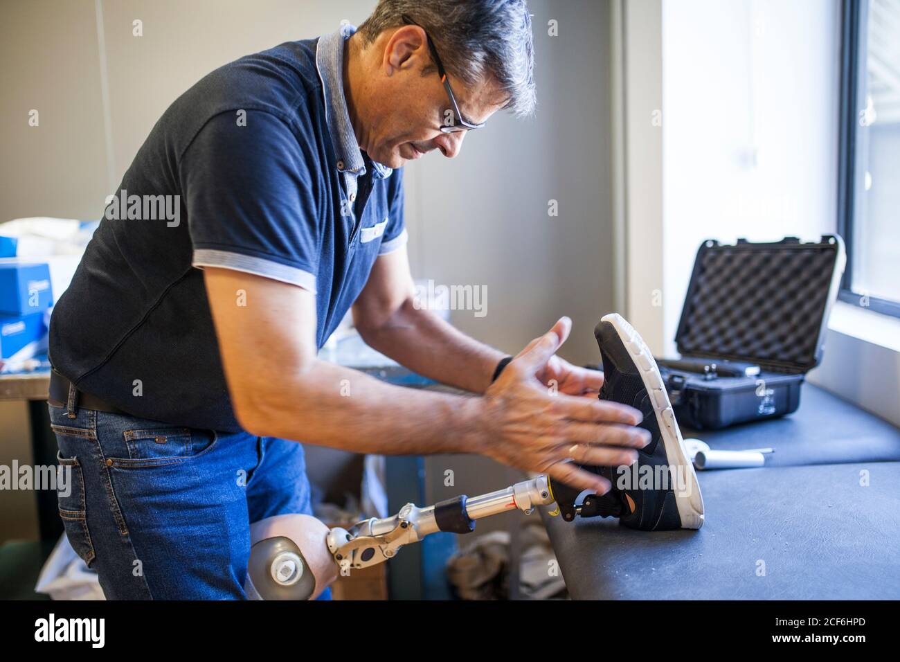 Prosthetic engineer reviewing the prosthesis of a patient and improving ...