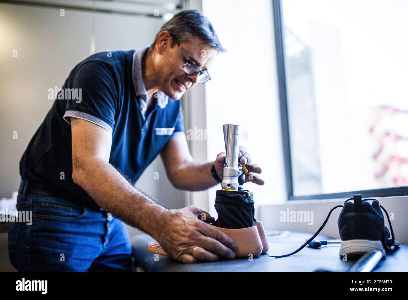 Prosthetic engineer reviewing the prosthesis of a patient and improving ...