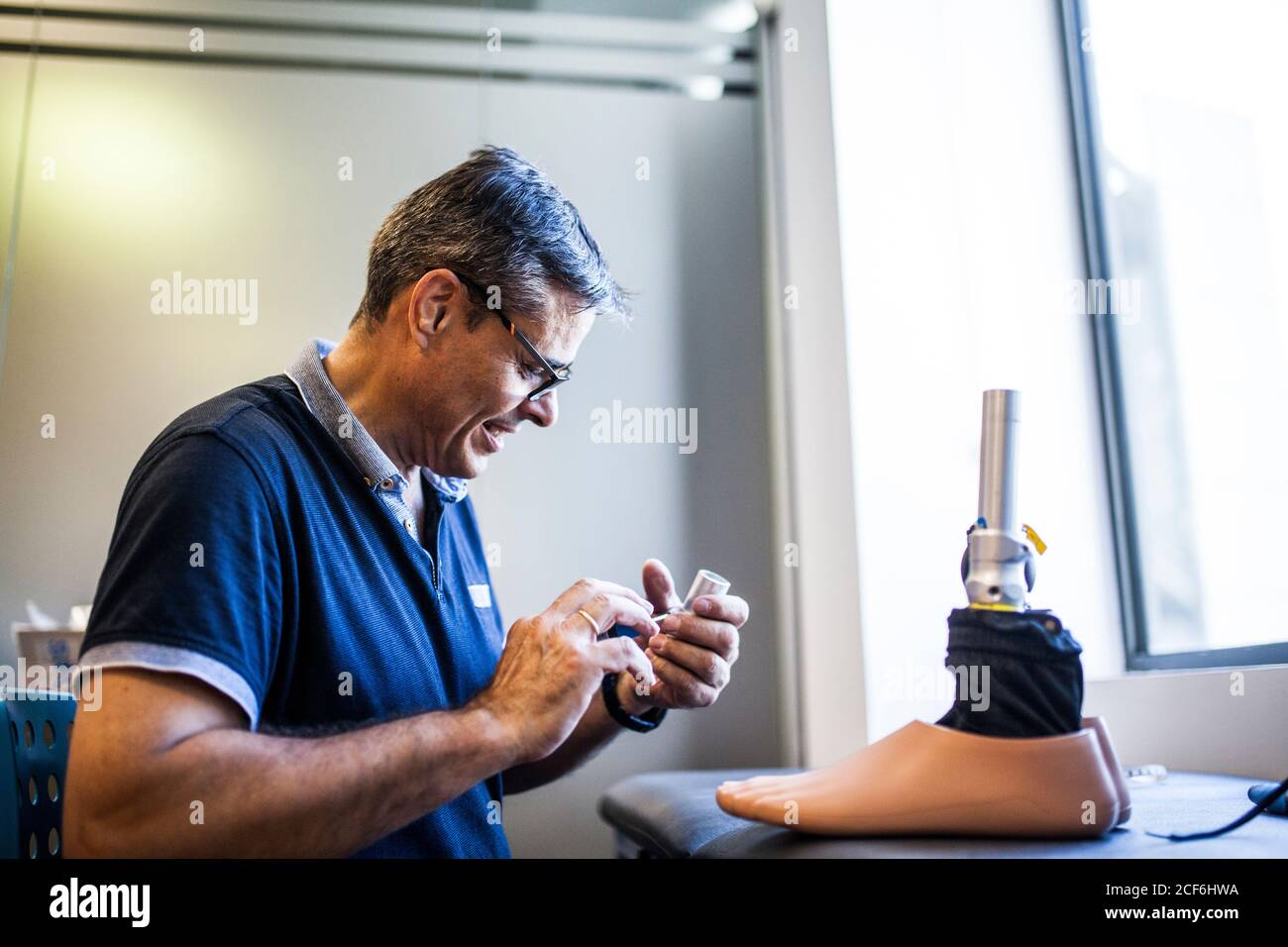 Prosthetic engineer reviewing the prosthesis of a patient and improving ...