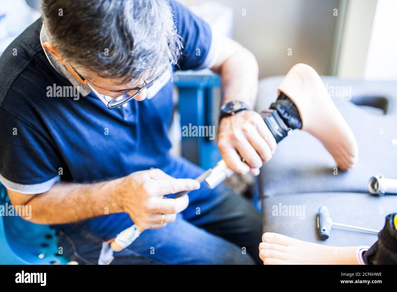 Prosthetic engineer reviewing the prosthesis of a patient and improving ...