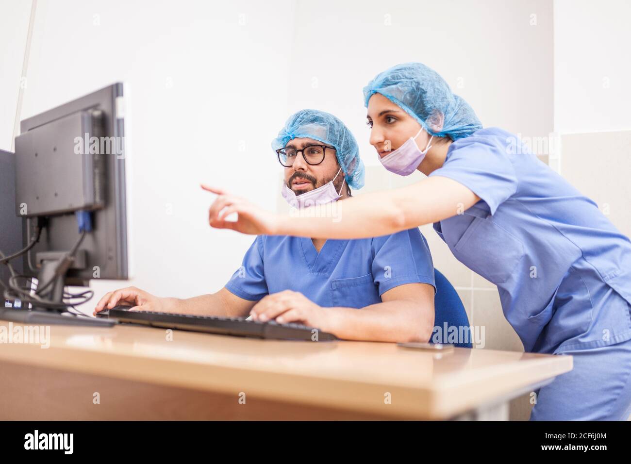 Team of surgeons, man and Woman using the computer before the surgery ...