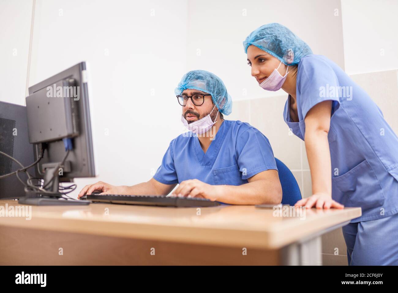Team of surgeons, man and Woman using the computer before the surgery ...