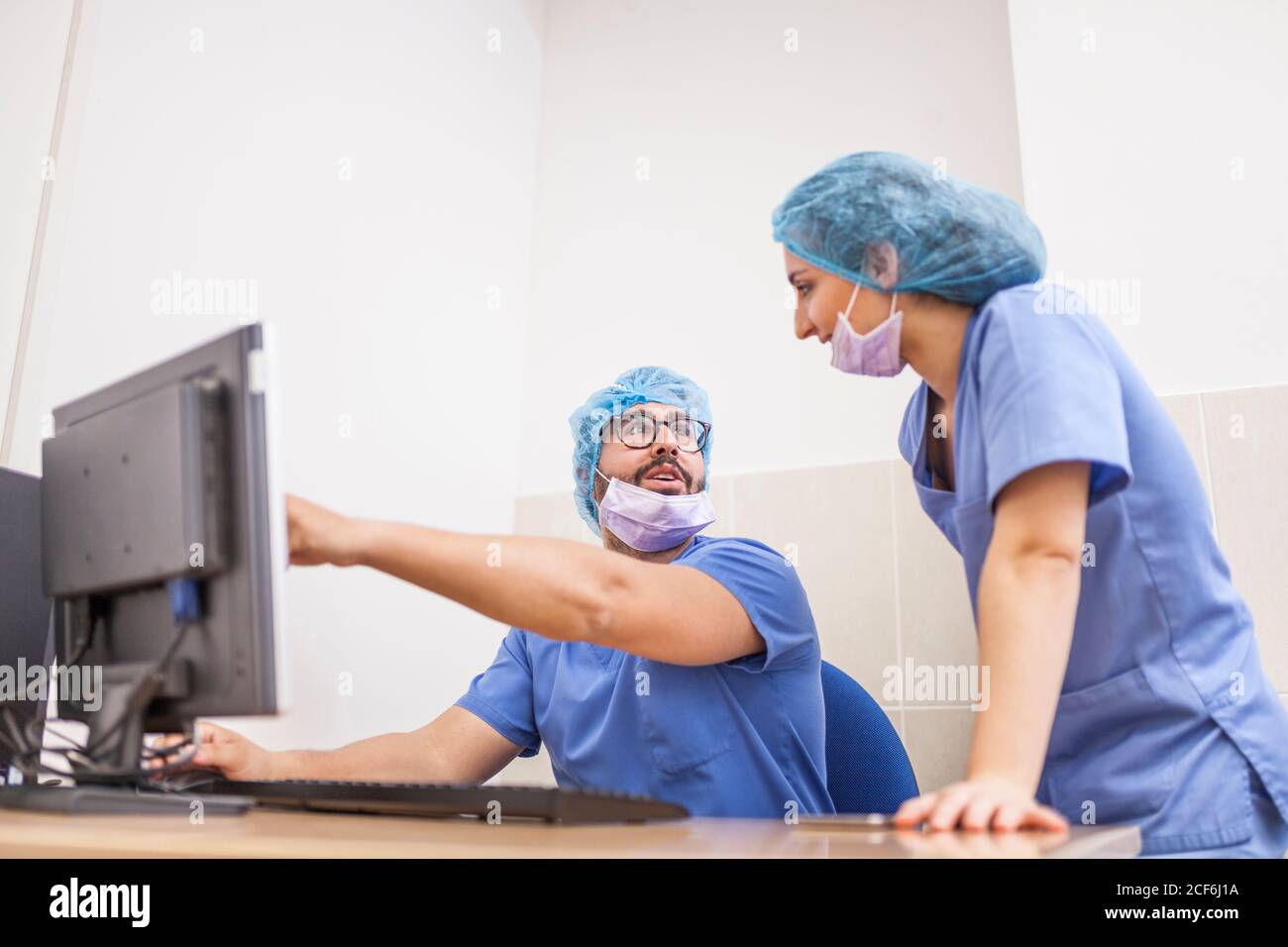Team of surgeons, man and Woman using the computer before the surgery ...