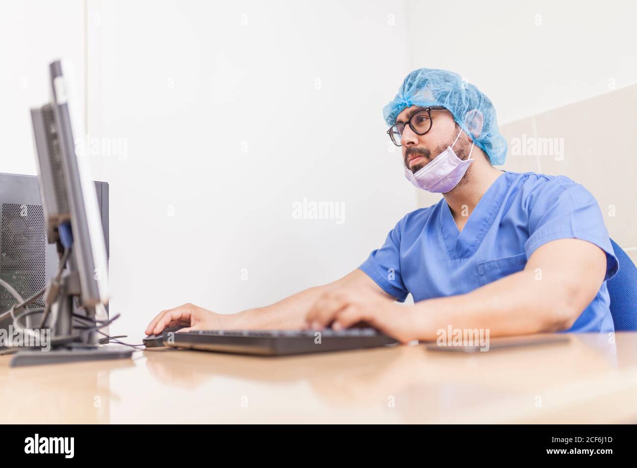 male surgeon using her computer in her office before the surgery Stock ...