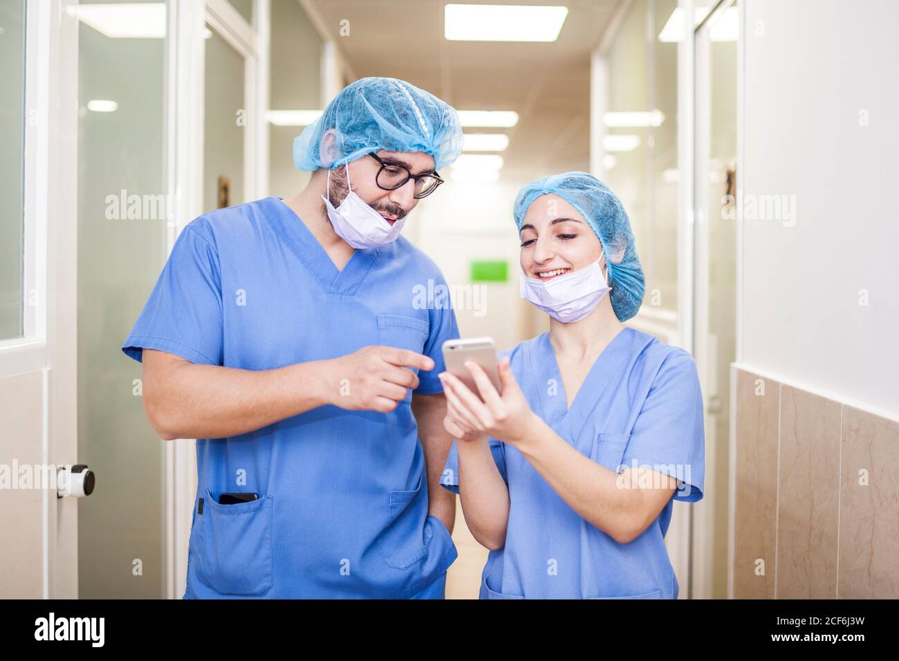 fellow surgeons man and Woman chat while walking to the operating room ...