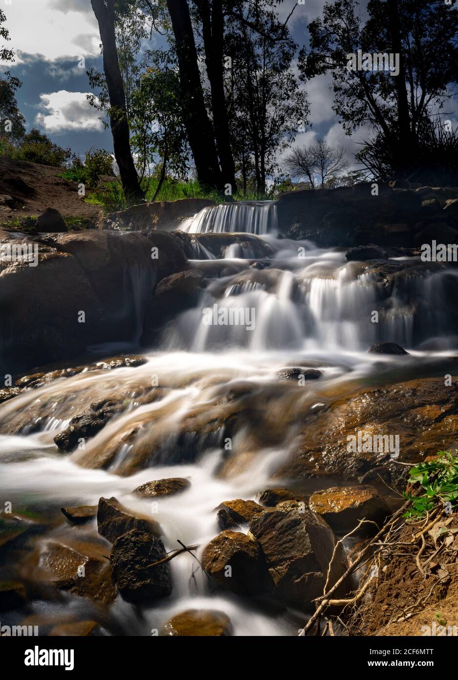 A waterfall in bush forest at regional national park with rock ...