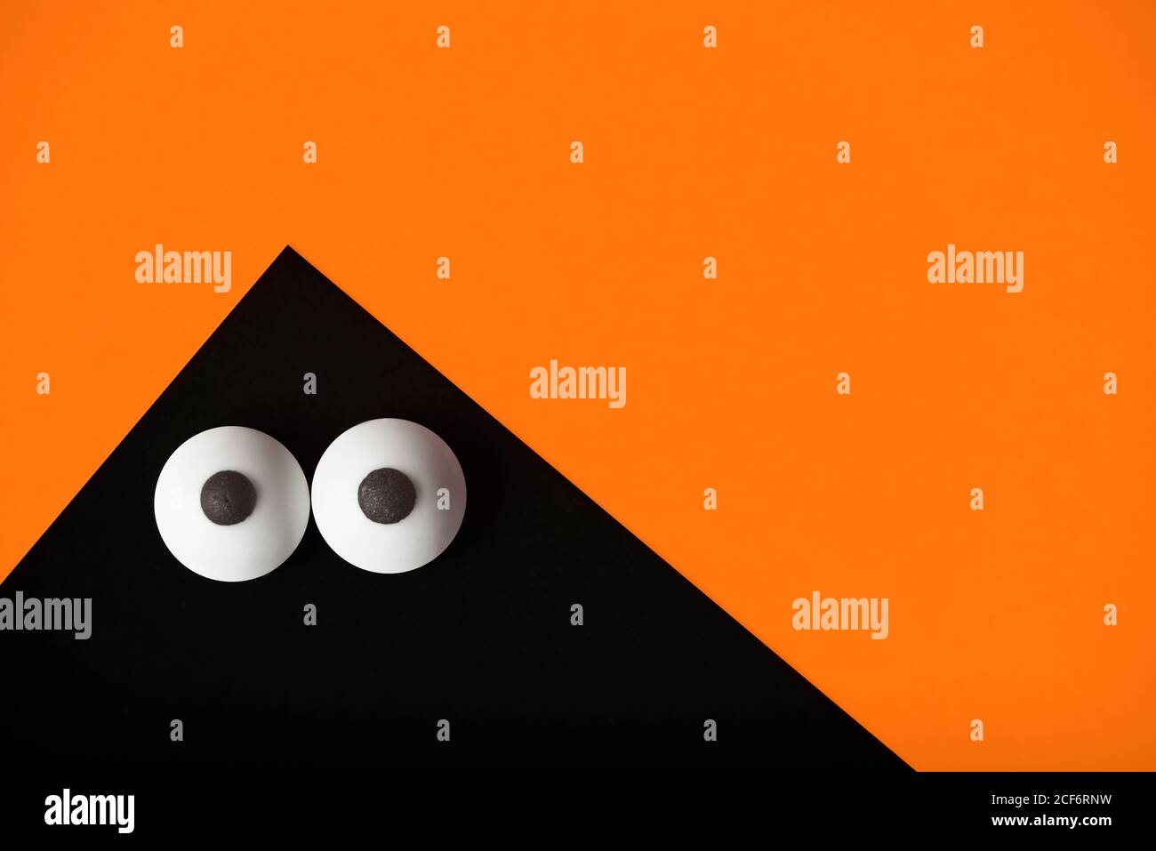 Halloween background, Black ghost with bulging eyes on orange, copy ...