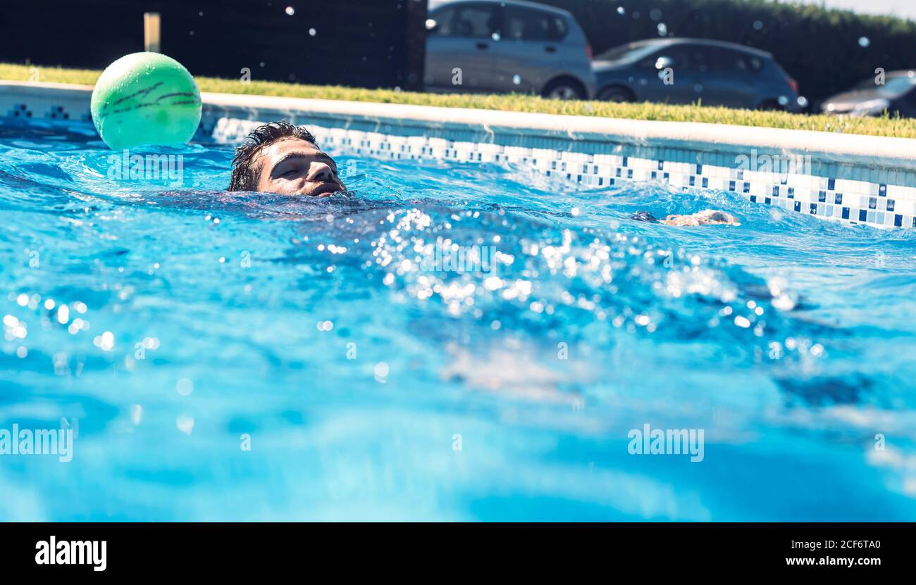 man floating in swimming pool Stock Photo - Alamy