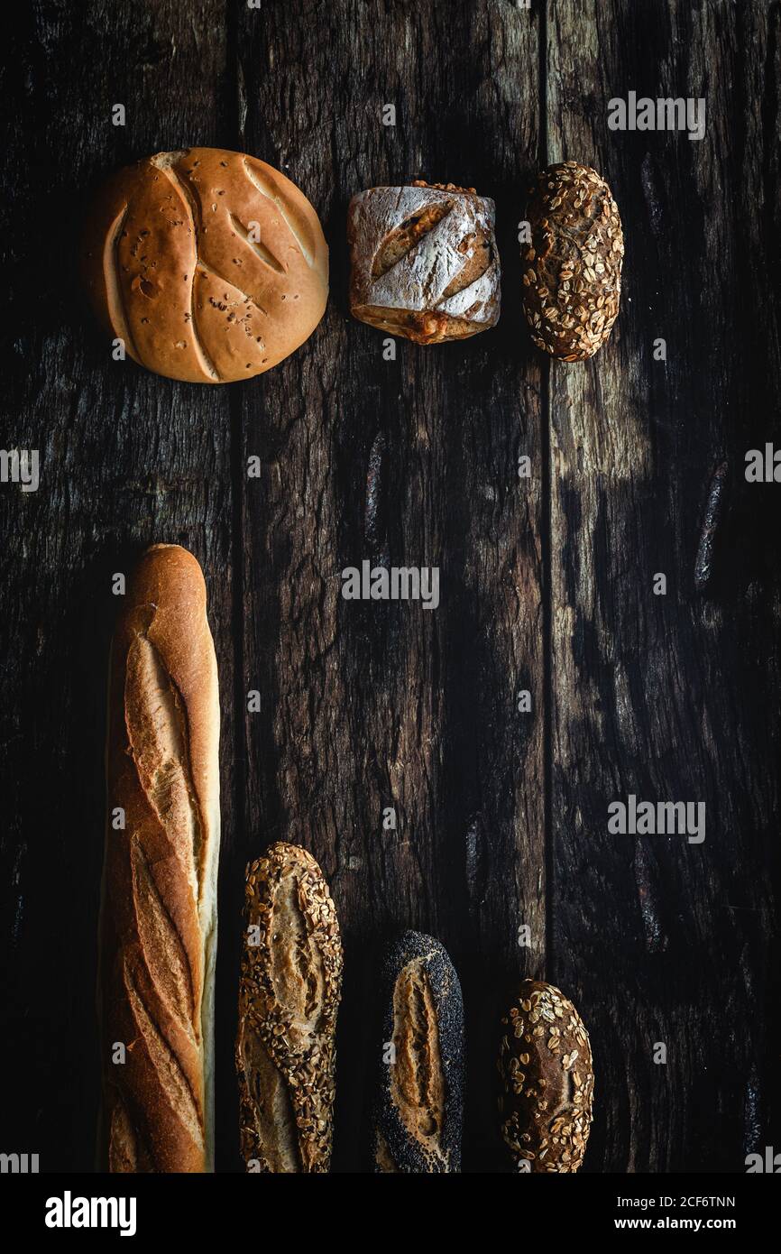 Gold assortment bread homemade on dark wood background, captured from ...