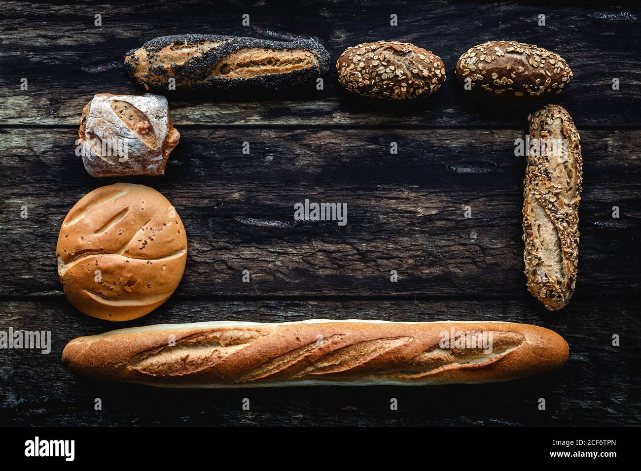 Gold assortment bread homemade on dark wood background, captured from ...
