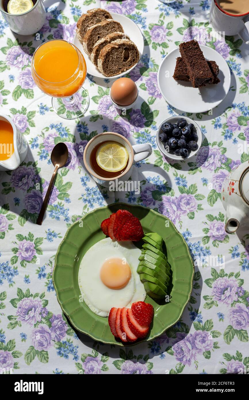 Homemade full healthy breakfast in sunlight with eggs, avocado ...