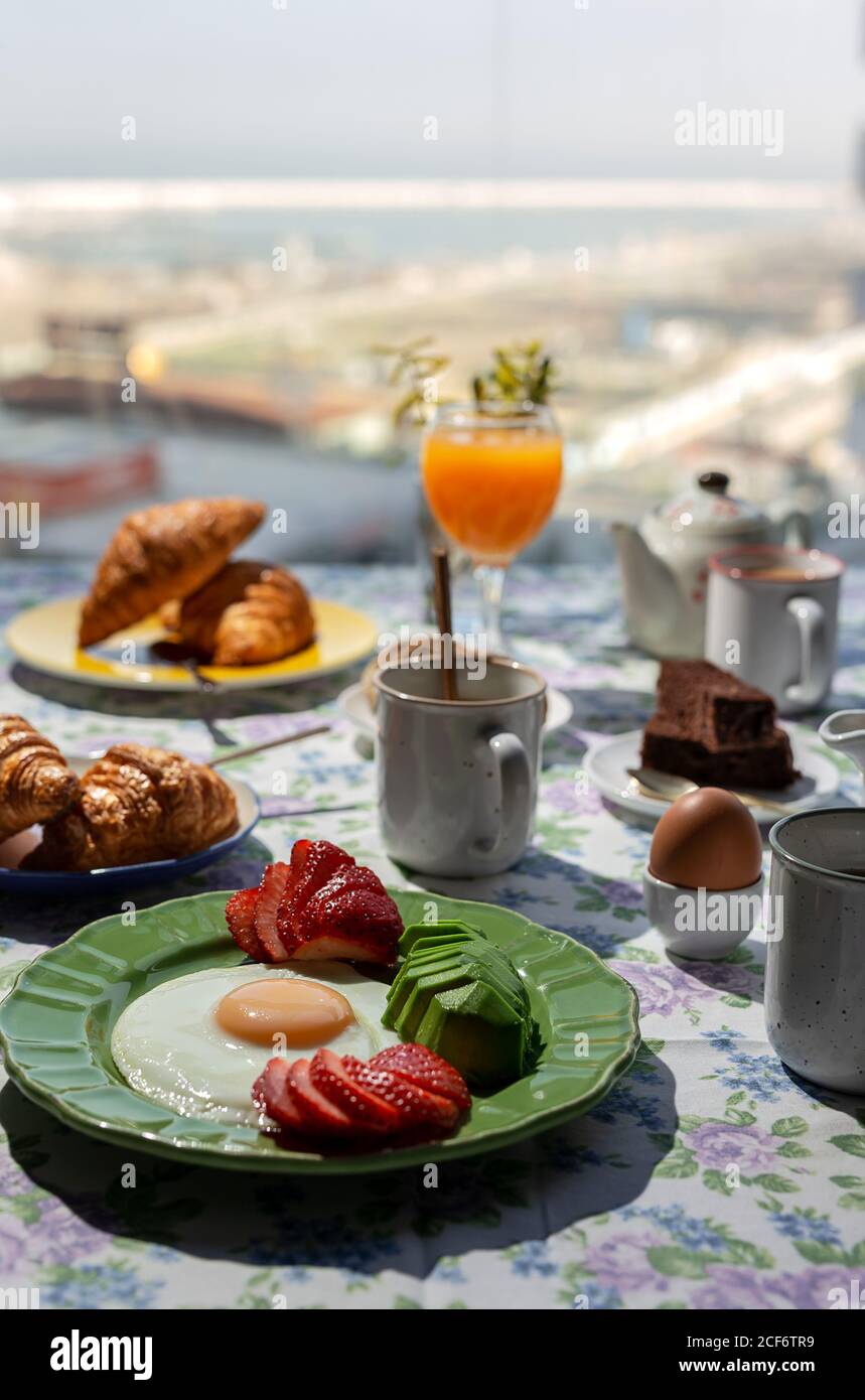 Homemade full healthy breakfast in sunlight with eggs, avocado ...