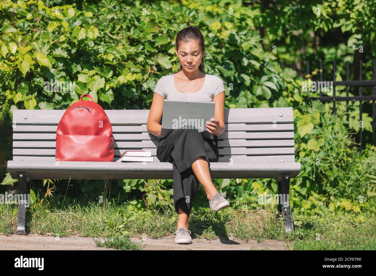 University student watching a live stream video of an online class ...