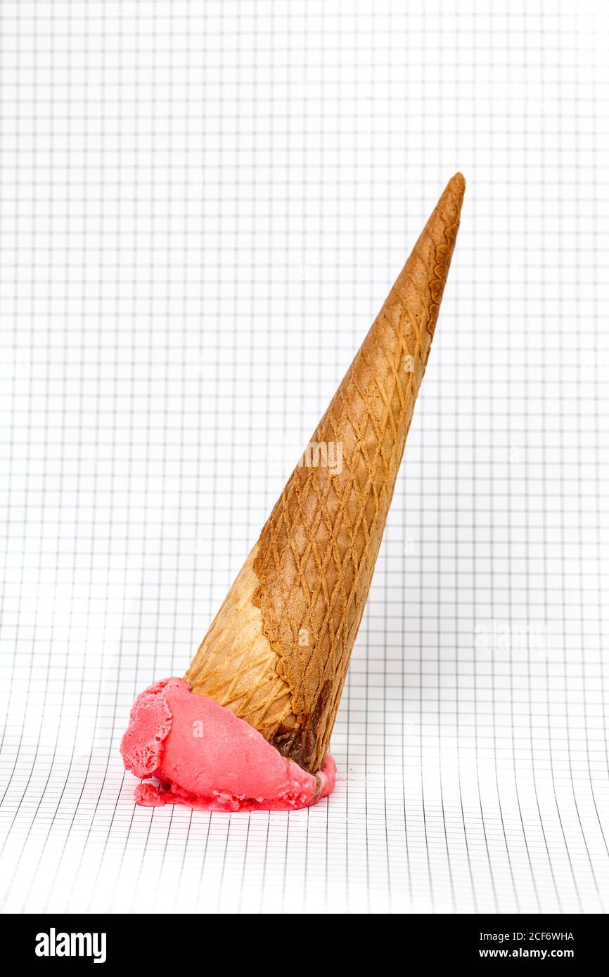 Ice cream cone dropped on graph paper Stock Photo - Alamy