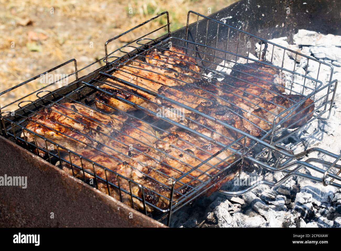 grilled meat on the charcoal grill. Embers smoke ash Stock Photo - Alamy
