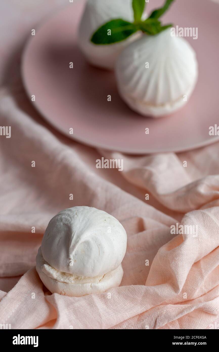 Homemade white Zefir traditional russian dessert with mint on pink ...