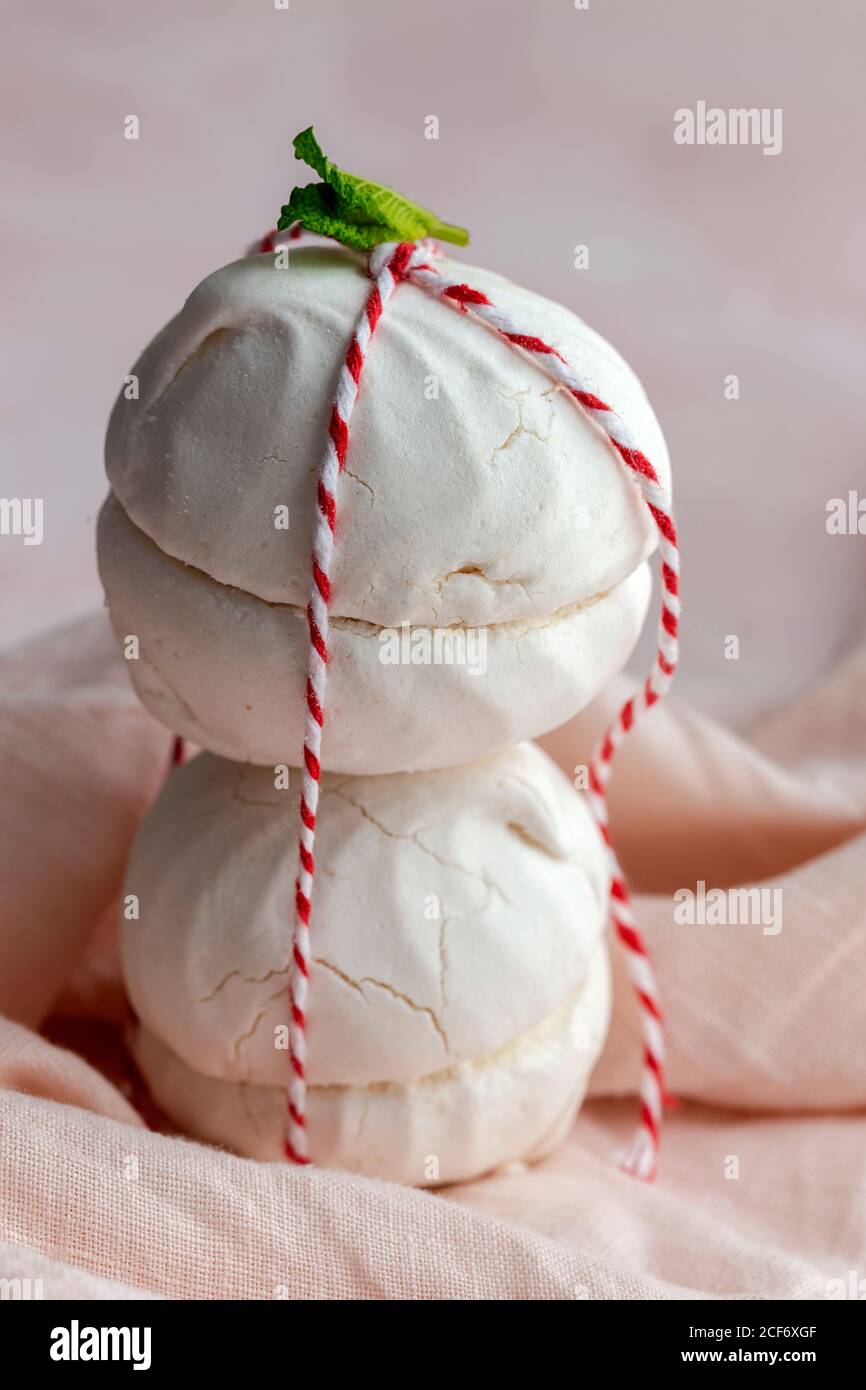 Homemade white Zefir traditional russian dessert hold by a small rope ...