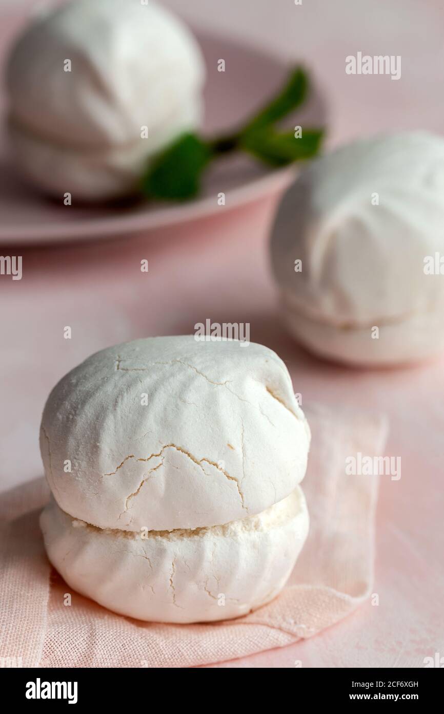 Homemade white Zefir traditional russian dessert with mint on pink ...