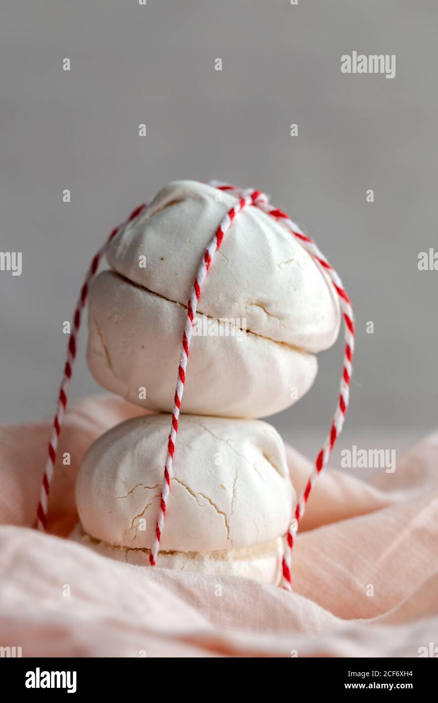 Homemade white Zefir traditional russian dessert hold by a small rope ...