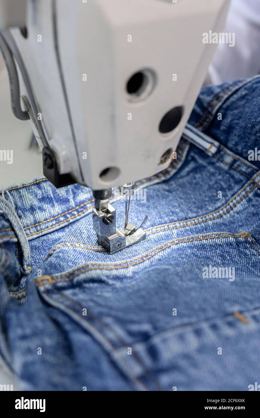 Working Woman hands in textile factory sewing on industrial sewing ...