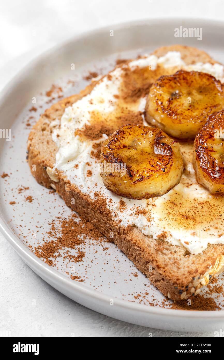 Homemade toasted bread with cream cheese, fried banana, honey and ...