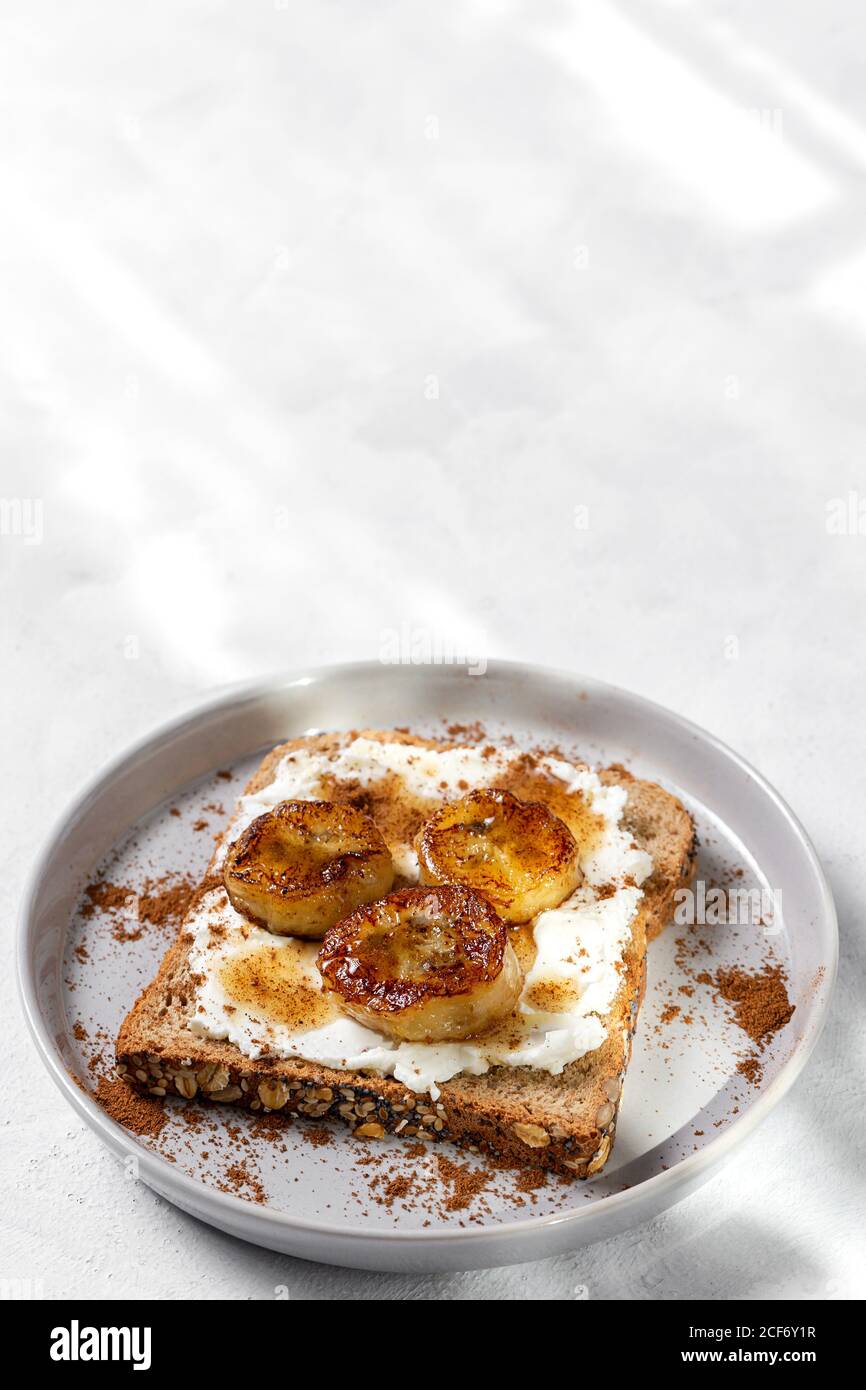 Homemade toasted bread with cream cheese, fried banana, honey and ...