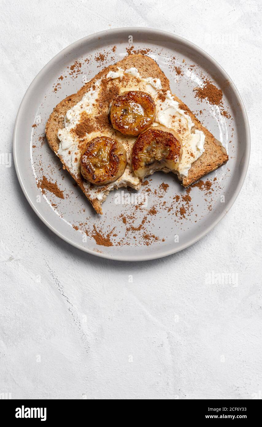 Homemade toasted bread from above with cream cheese, fried banana ...
