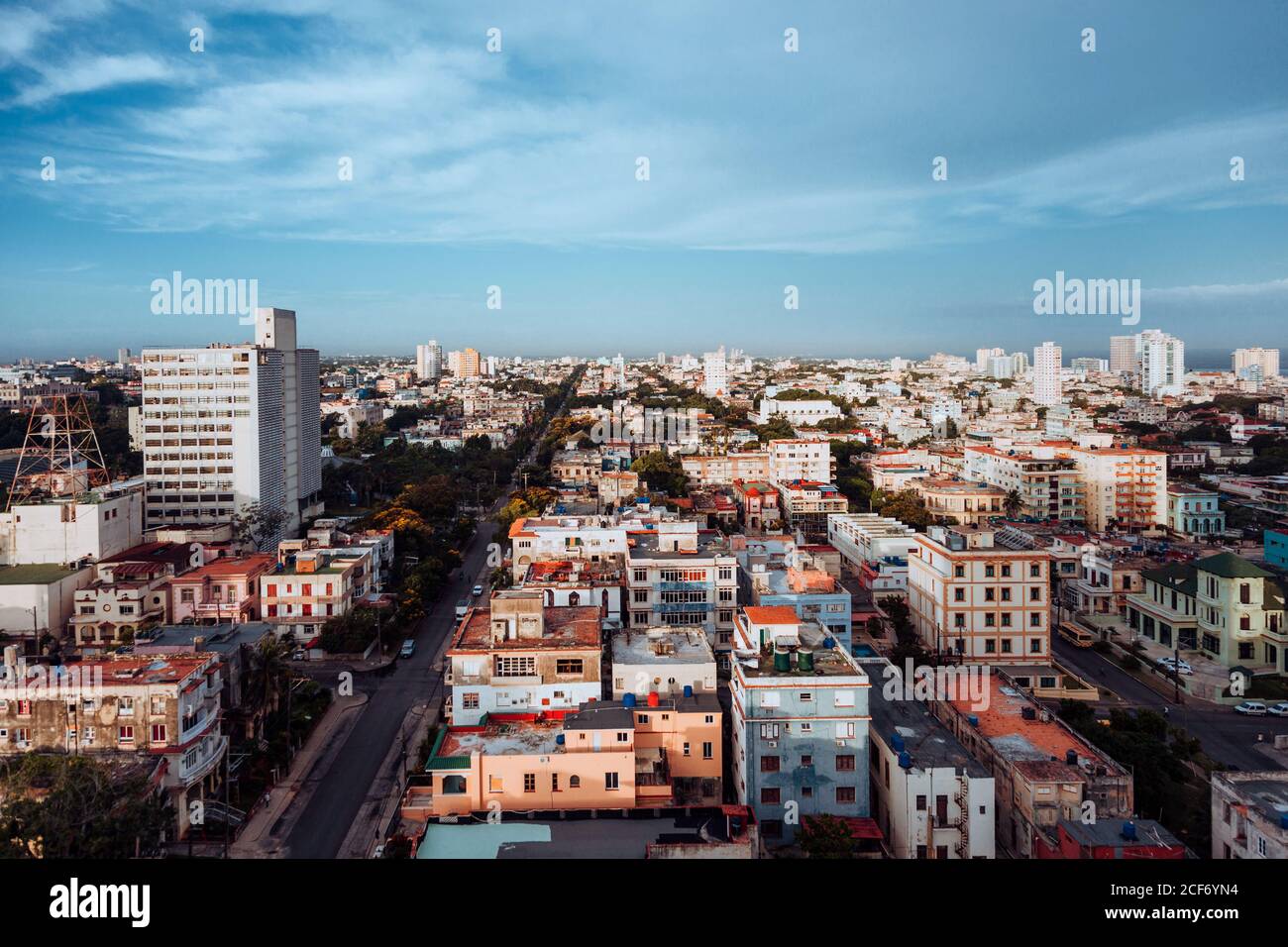 From above of colorful buildings and skyscraper with blue sky on ...
