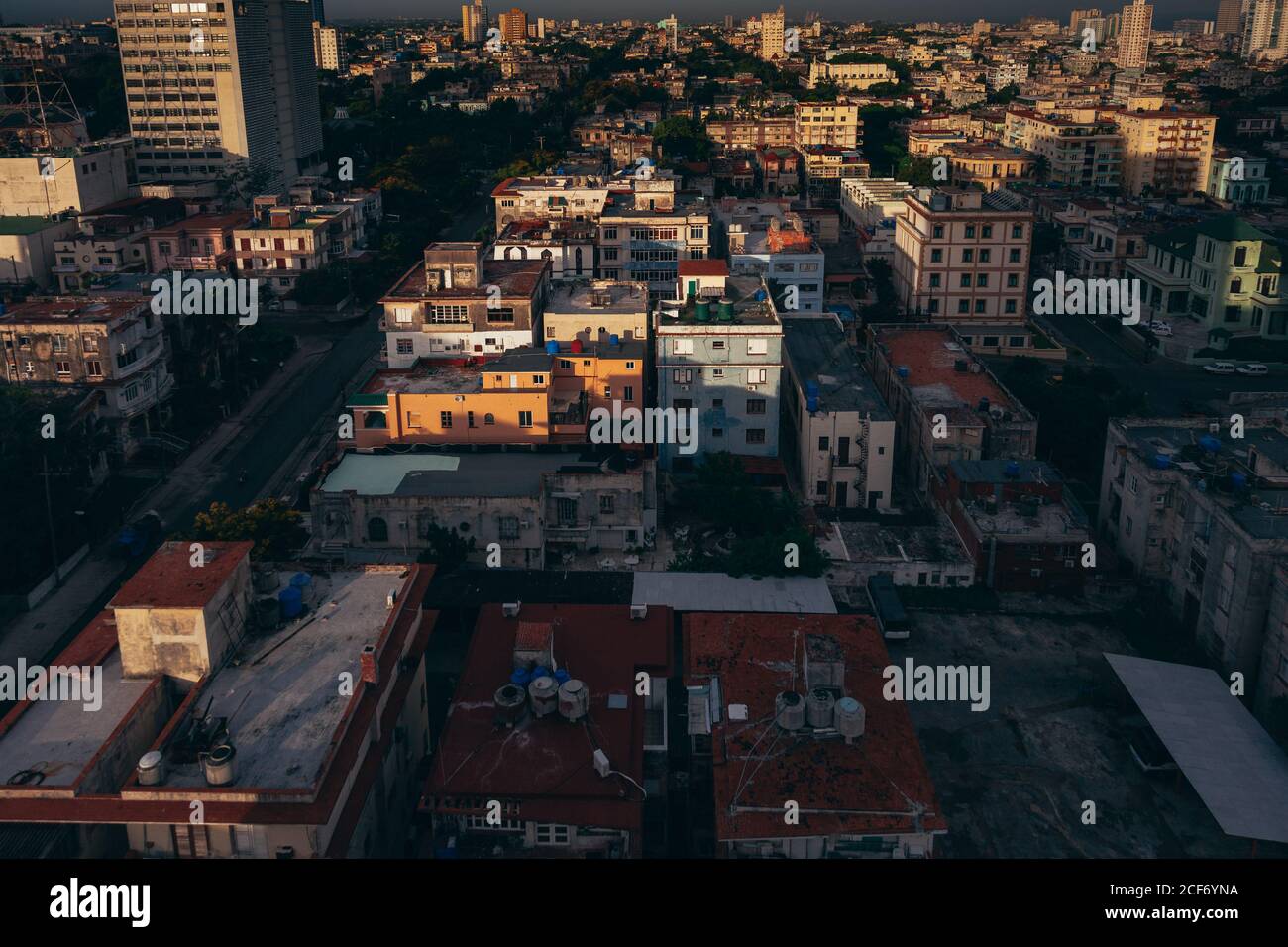 From above of colorful buildings and skyscraper with blue sky on ...