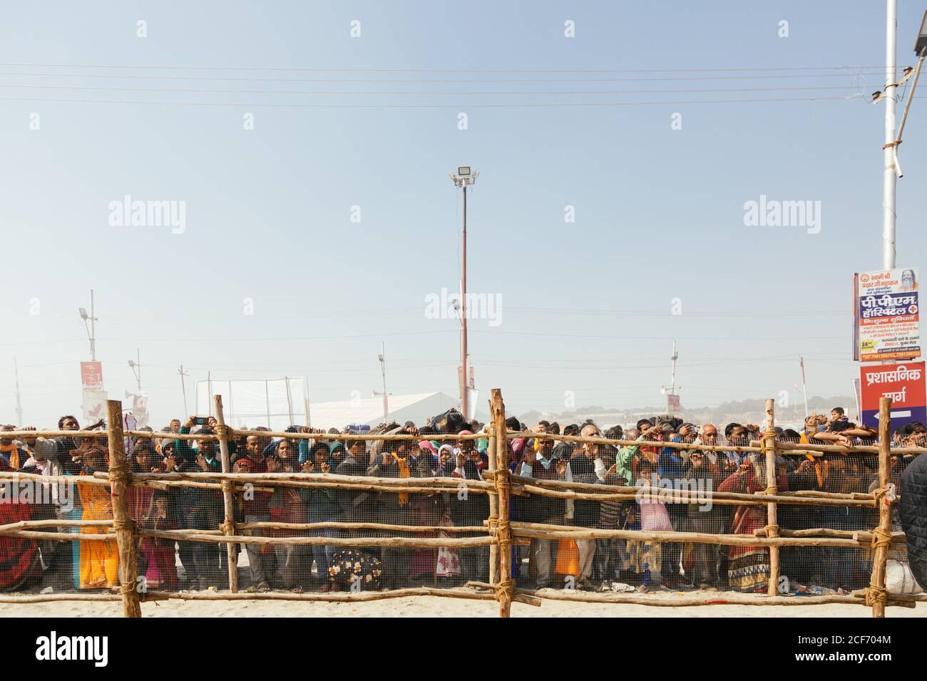 Group of people standing behind fence hi-res stock photography and ...