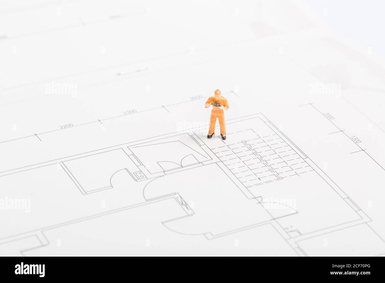 Building renovation drawings and miniature workers Stock Photo - Alamy